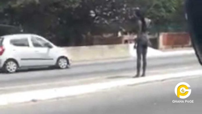 Lady pours libation to curse her enemies near the Jubilee House