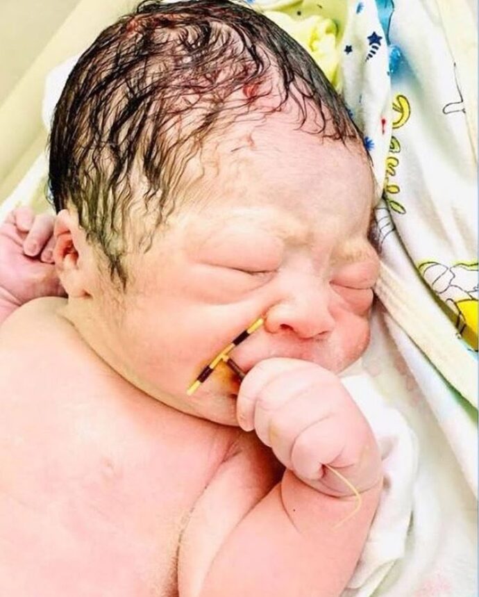 Newborn baby holds mum’s IUD contraceptive that failed to stop her ...